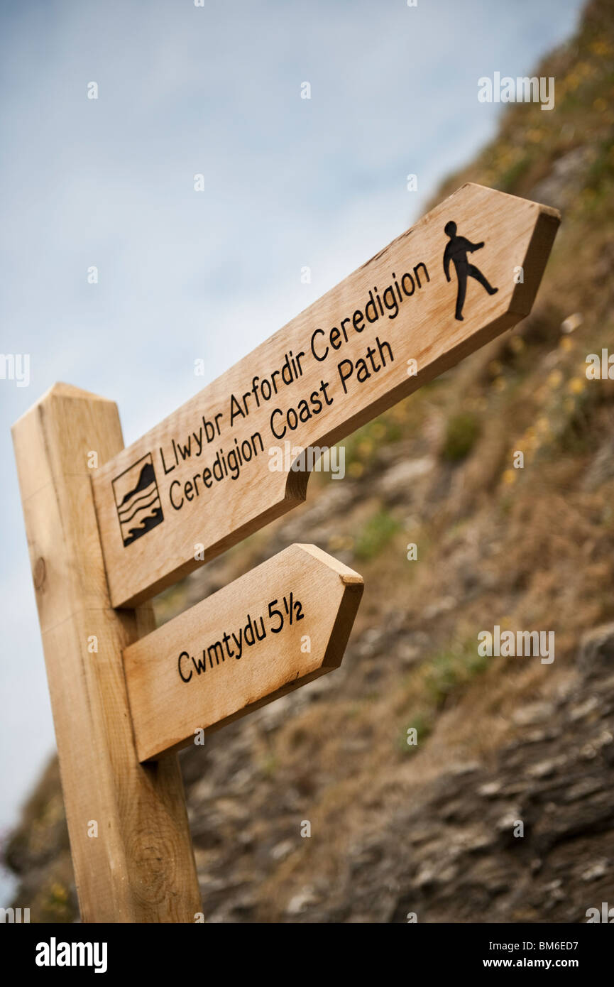 Wooden bilingual signposts for the Coast Path at Llangrannog ...