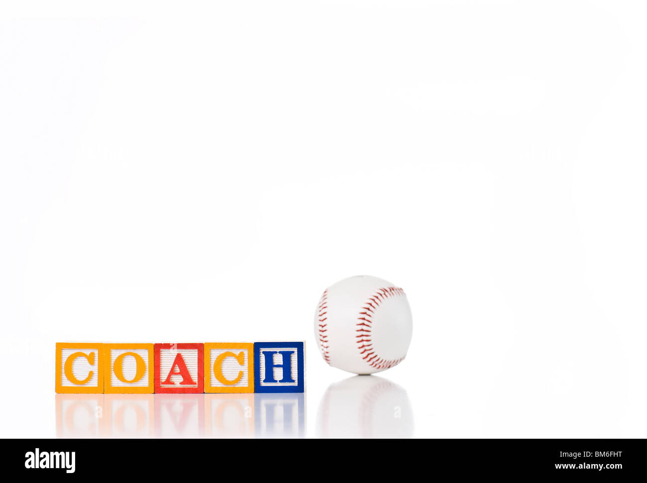 Colorful children's blocks spelling COACH with a baseball in the ...
