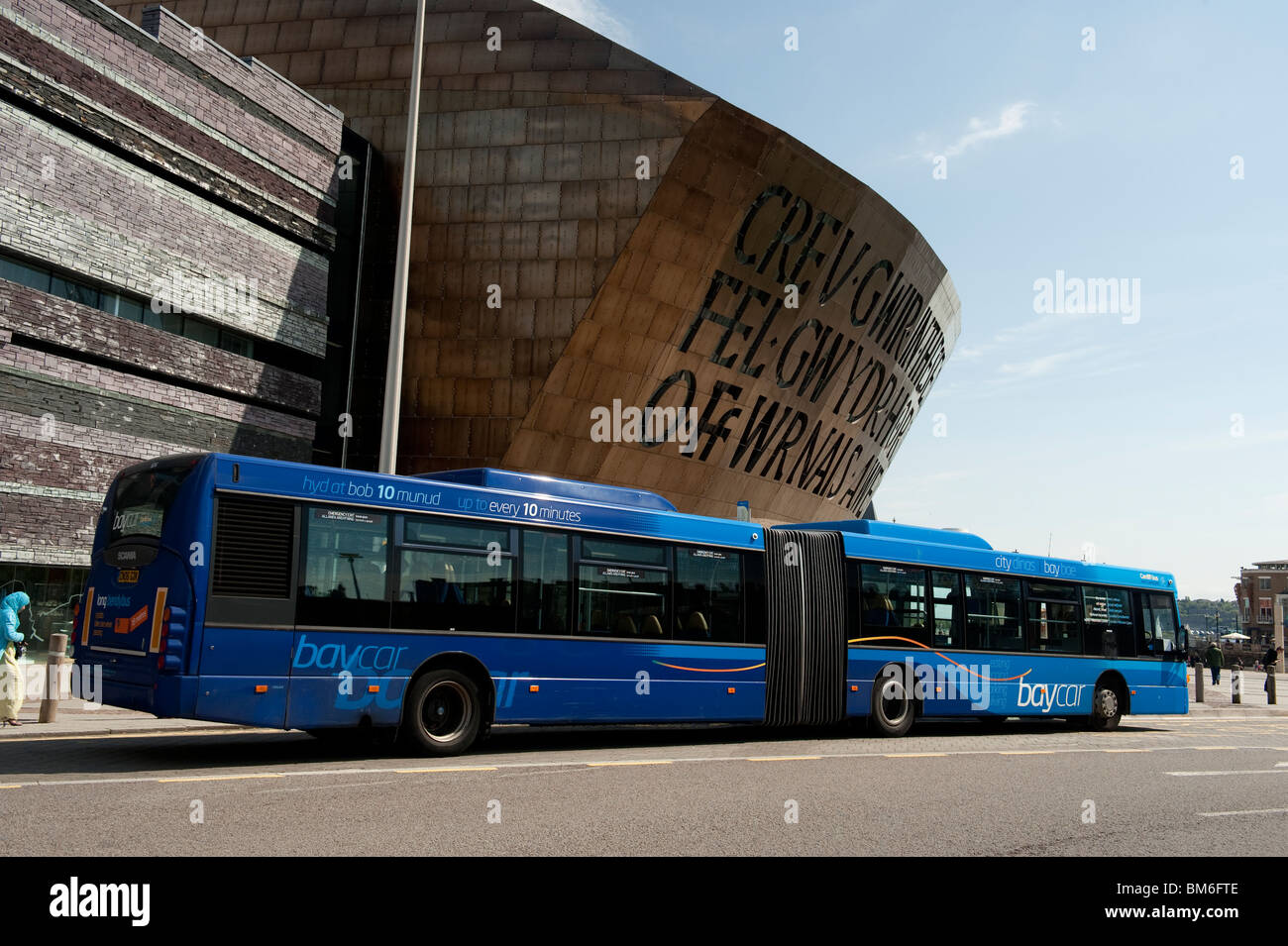 A blue BayCar bendy bus outside The Wales Millennium Centre, Cardiff ...