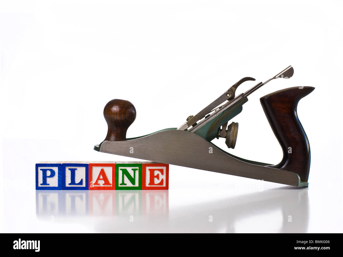 Colorful children's blocks spelling the word PLANE with a woodworking ...