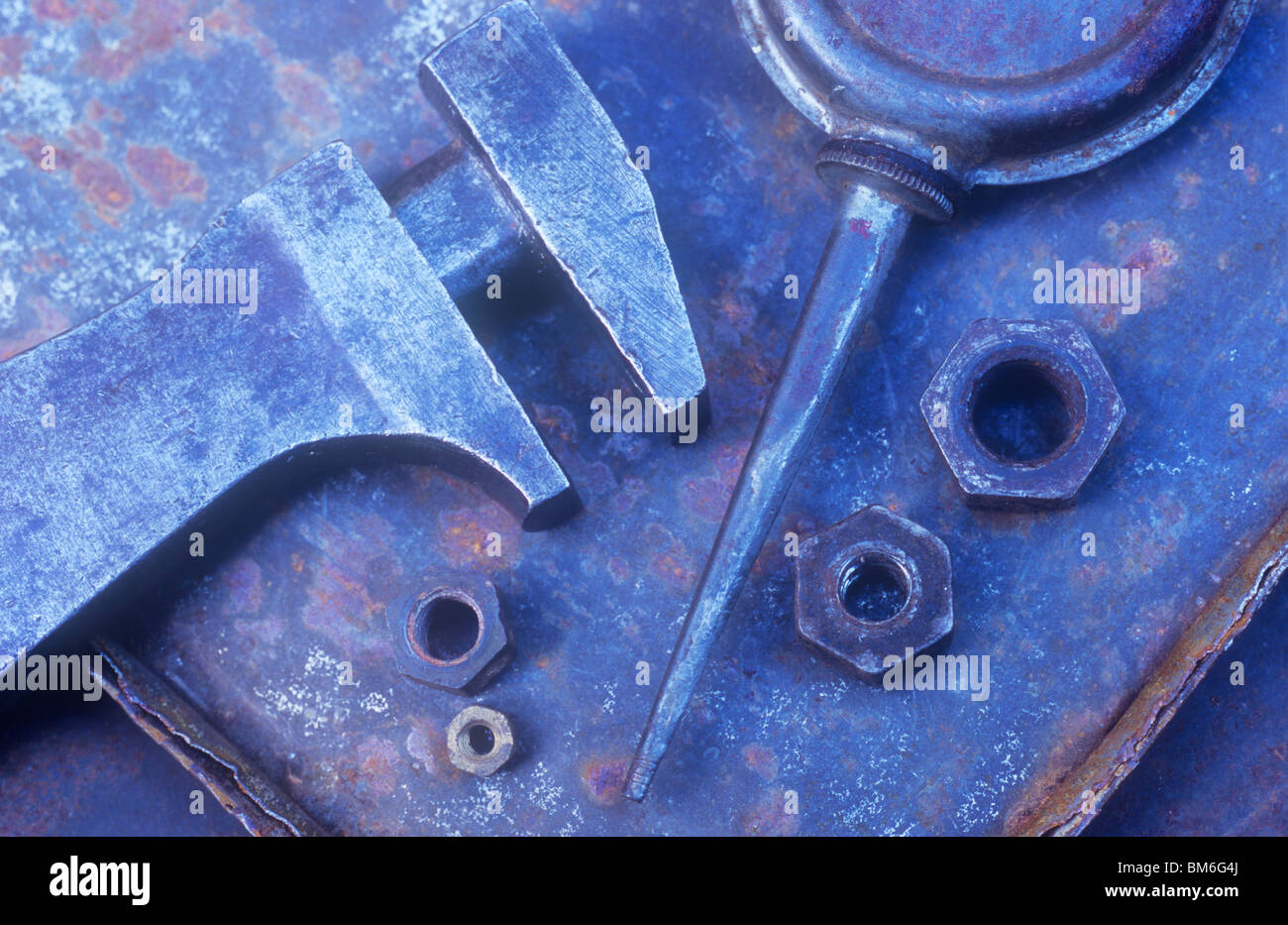 Small adjustable spanner or wrench lying with flat oilcan and metal ...