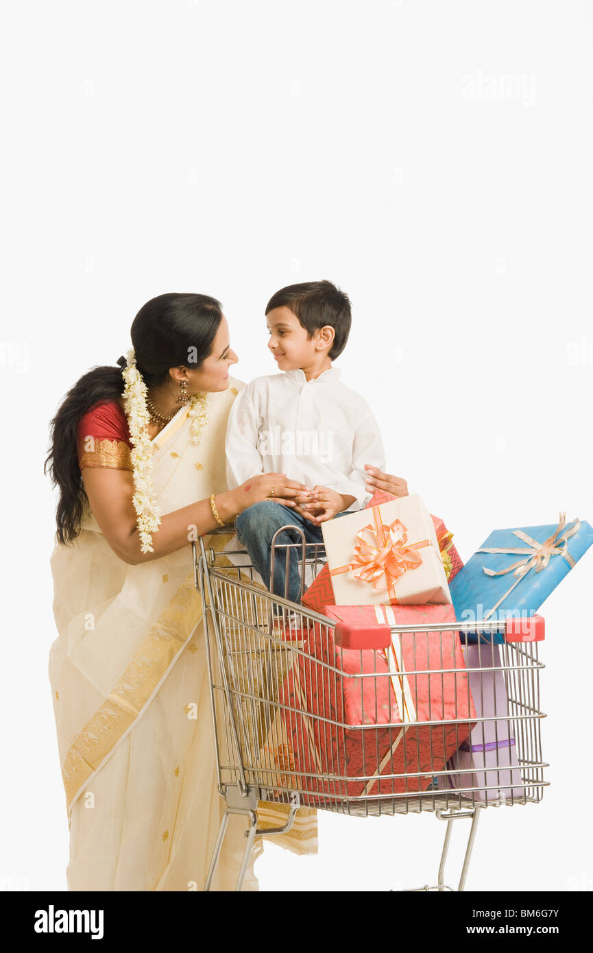 Woman and her son with a shopping cart Stock Photo - Alamy
