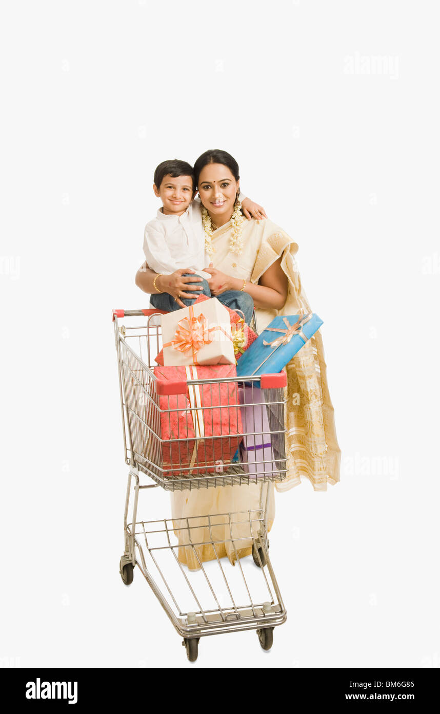 Woman and her son with a shopping cart Stock Photo - Alamy