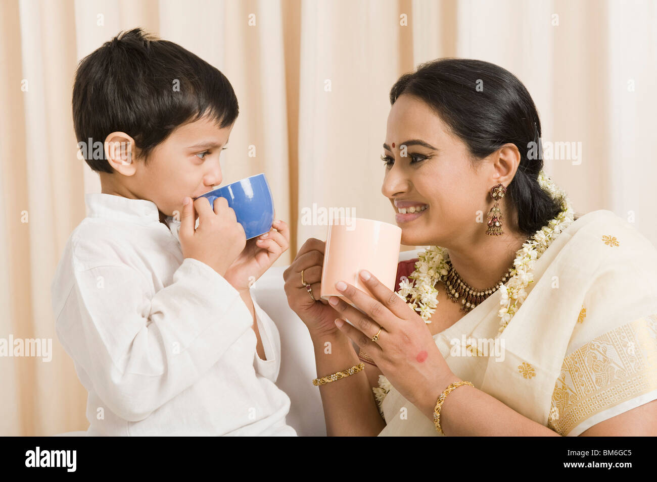 Woman with her son having coffee Stock Photo - Alamy