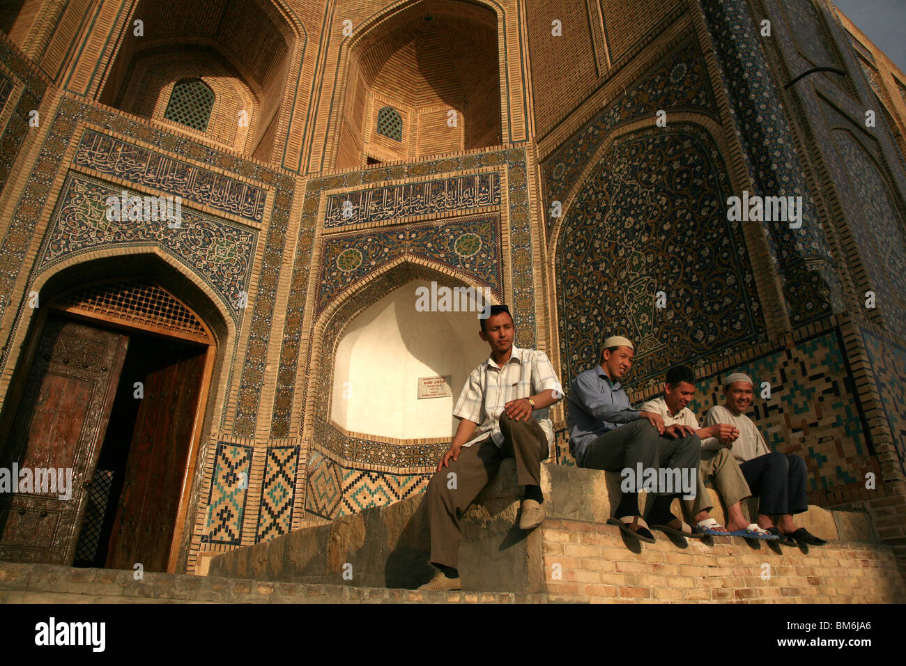 Madrassah students sitting in front of Mir-i Arab Madrassah in Bukhara ...
