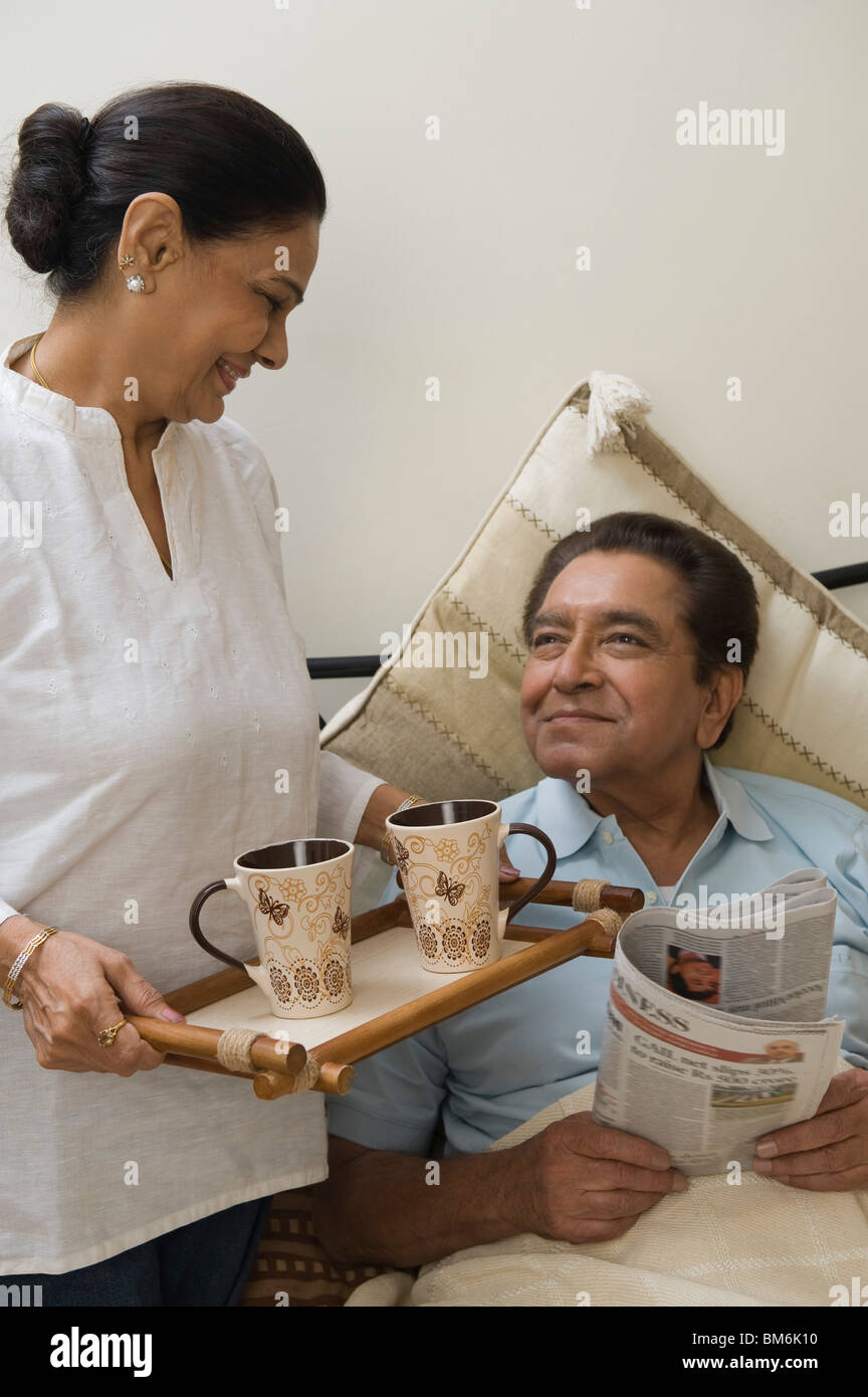 Woman bringing cup tea bed hi-res stock photography and images - Alamy