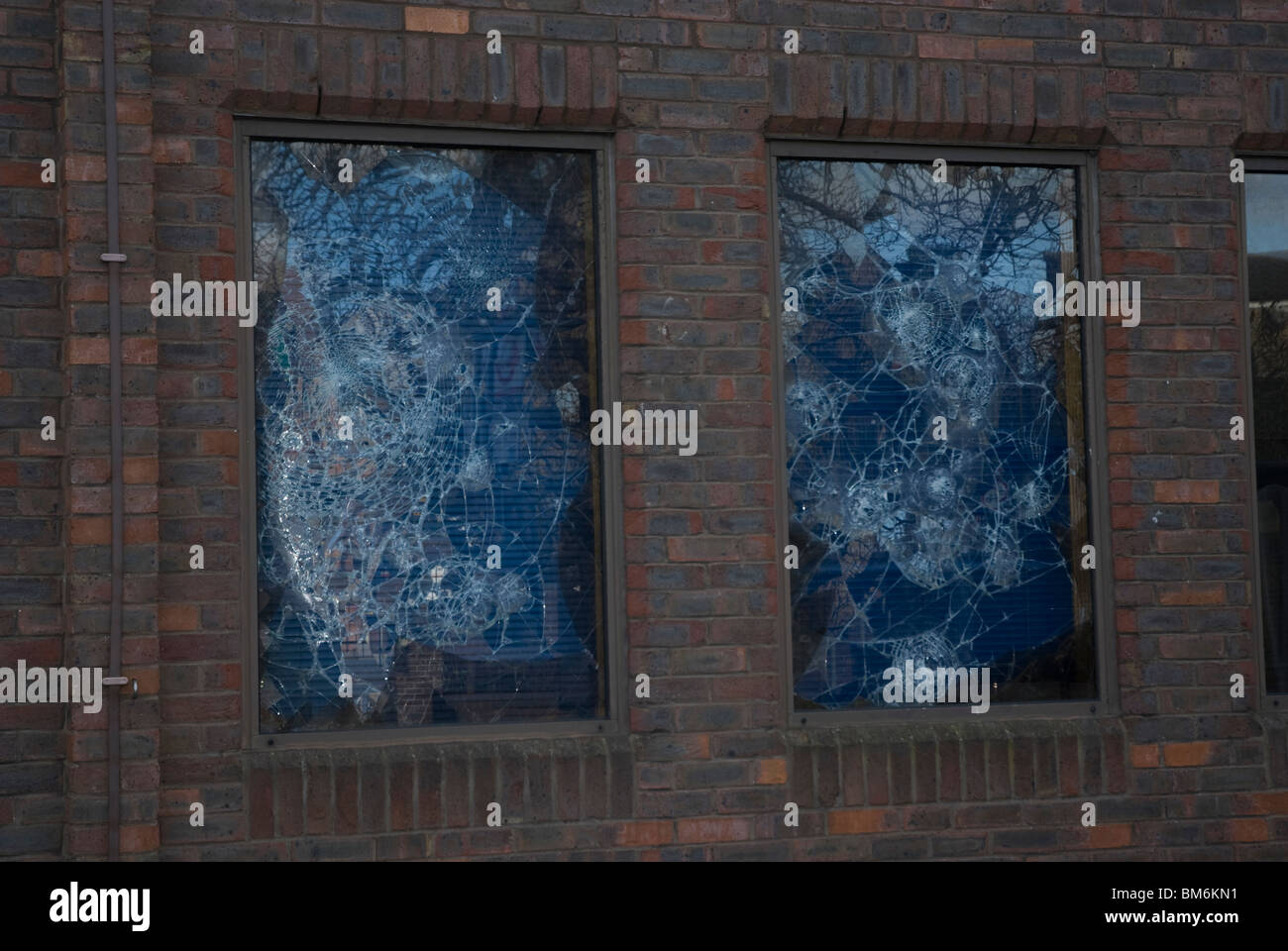 Two broken windows in a disused building Isleworth, West London England ...