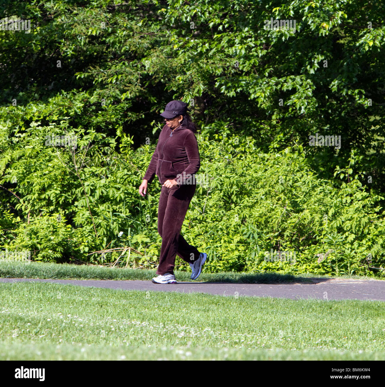 An African American senior woman walking in the park for exercise Stock ...