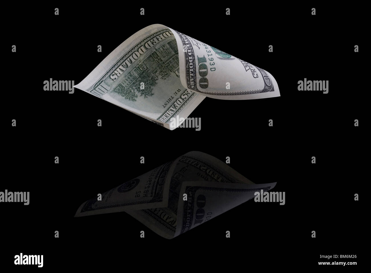 Falling hundred dollar bill on a black background with reflection Stock ...