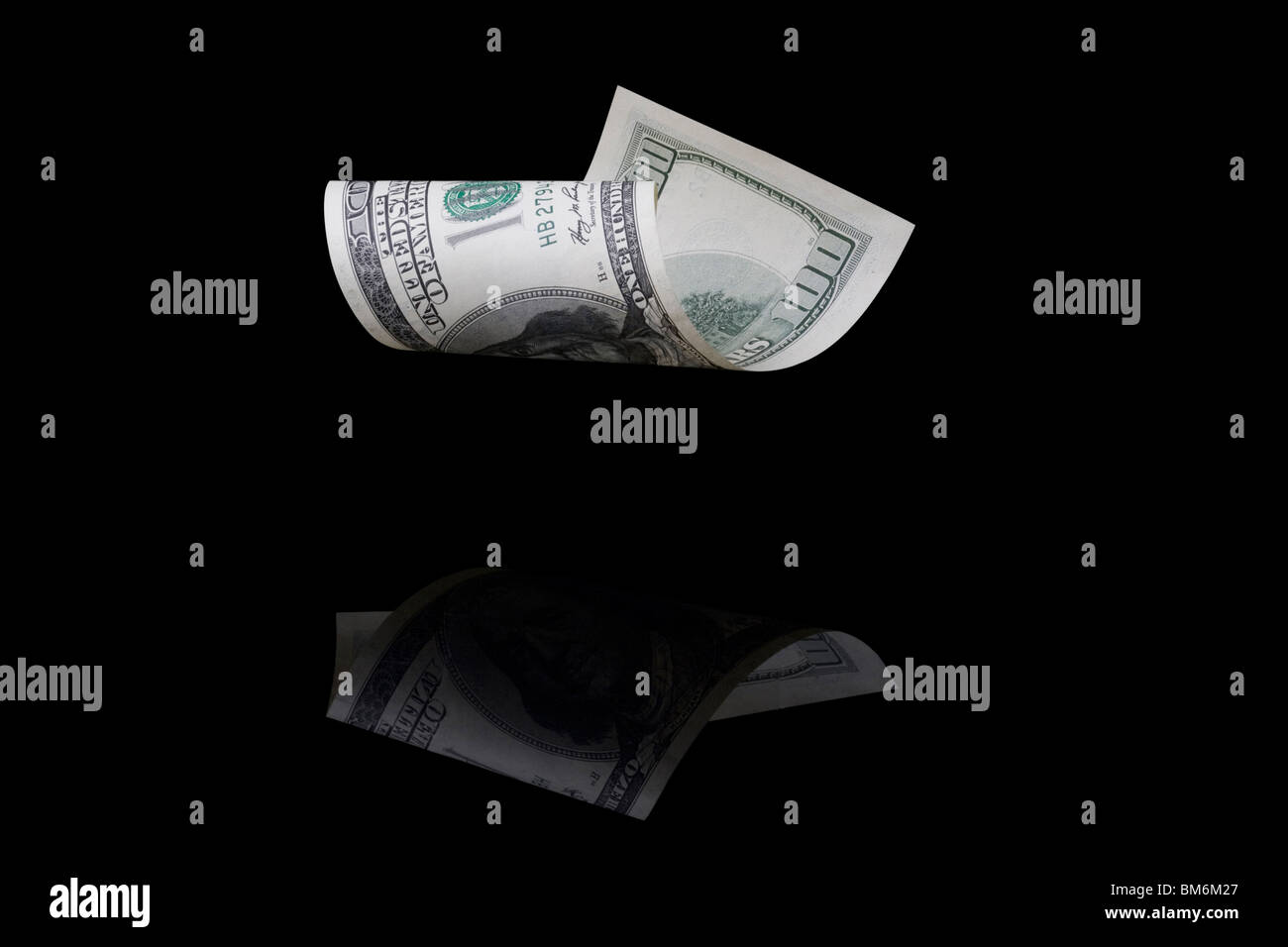 Falling hundred dollar bill on a black background with reflection Stock ...