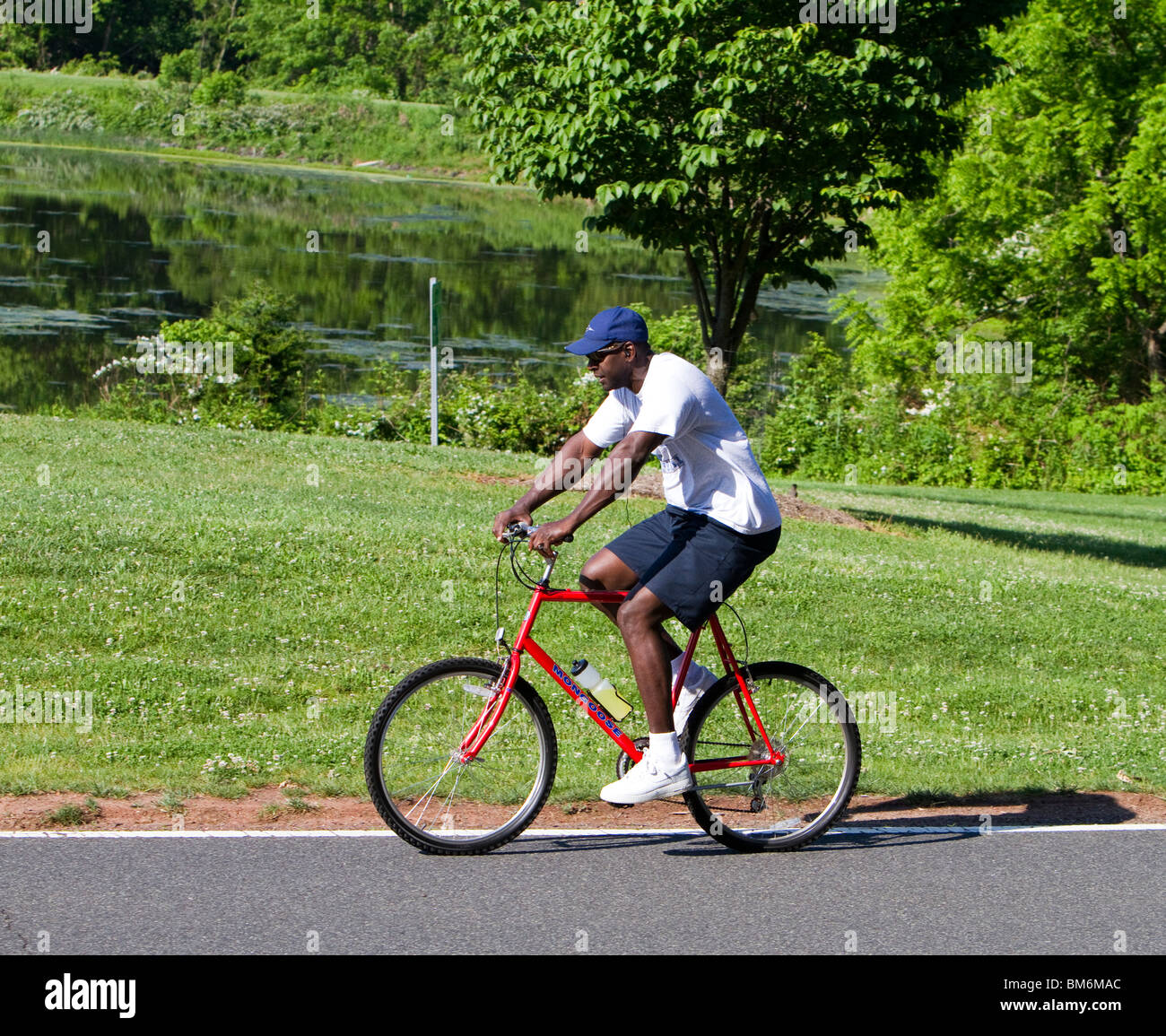 A black African Afro American man riding a cross training bike in the ...