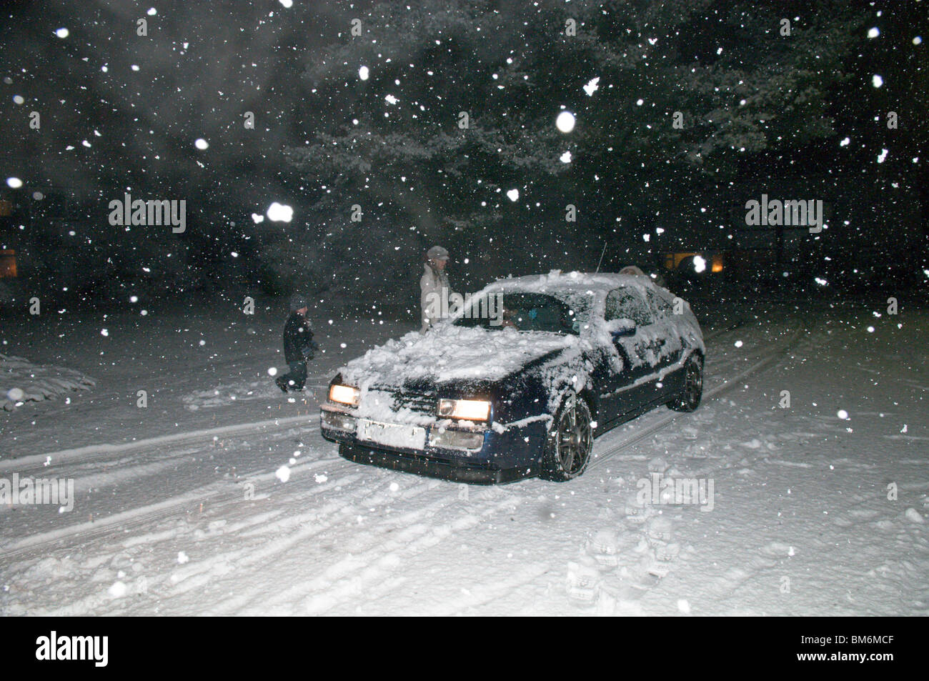 car being pushed in heavy snow at night Stock Photo - Alamy