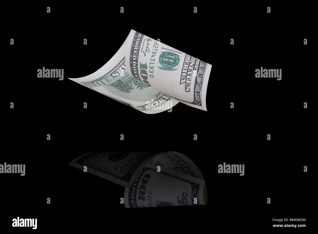 Falling hundred dollar bill on a black background with reflection Stock ...