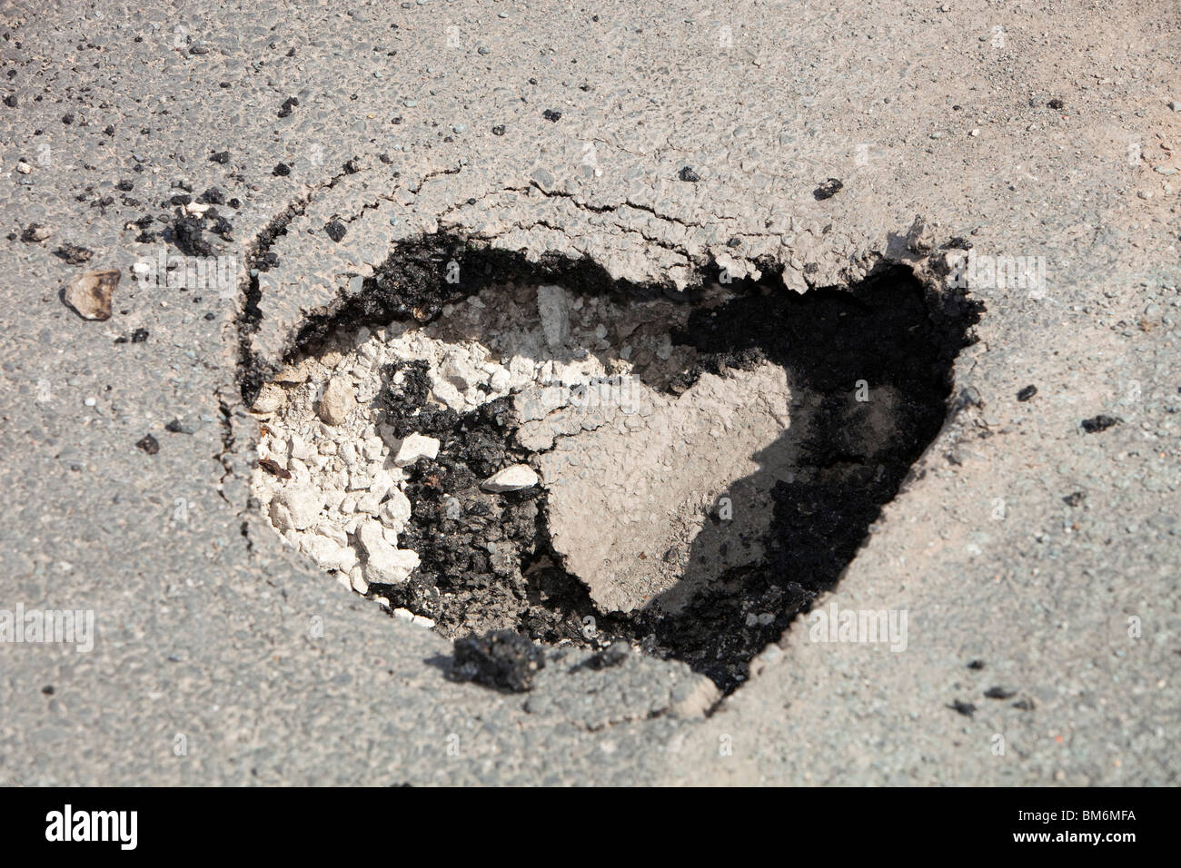 A hole opening up in the road in Ambleside, due to being undermined by ...