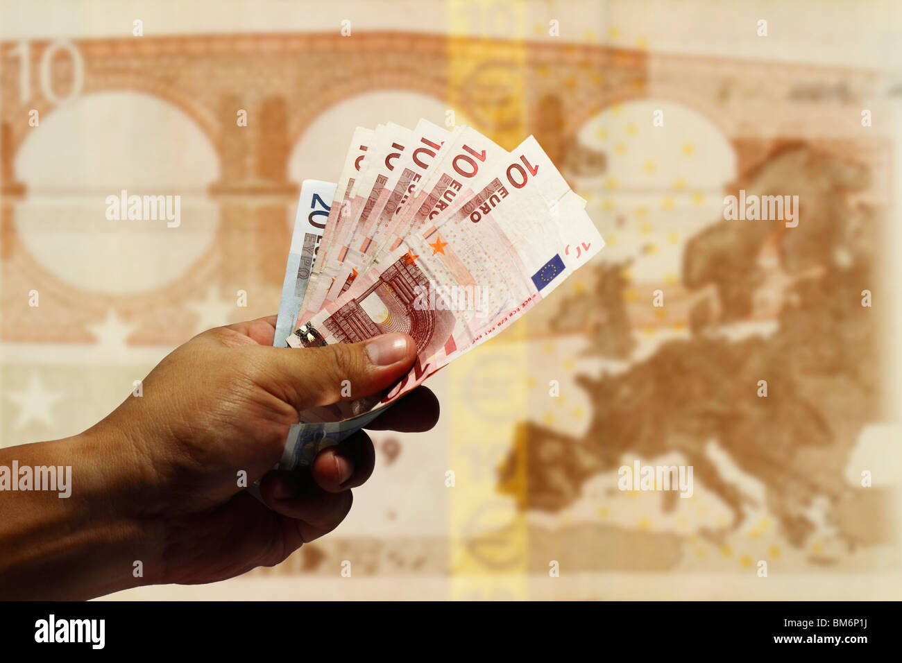 An image of a hand offering European currency Euro with the Euro as ...