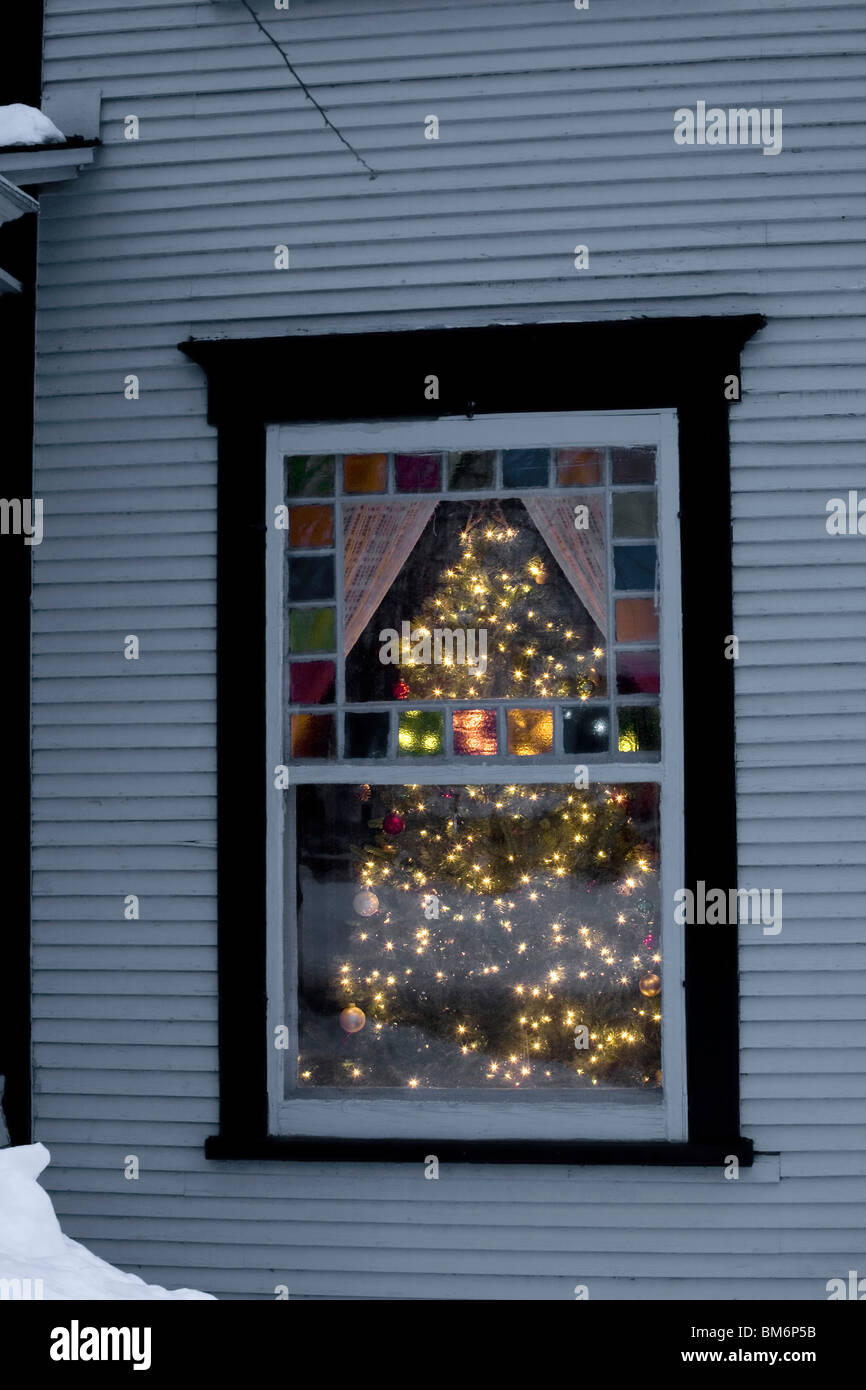 View Through A Window Of A Christmas Tree Lit Up With Lights Stock ...