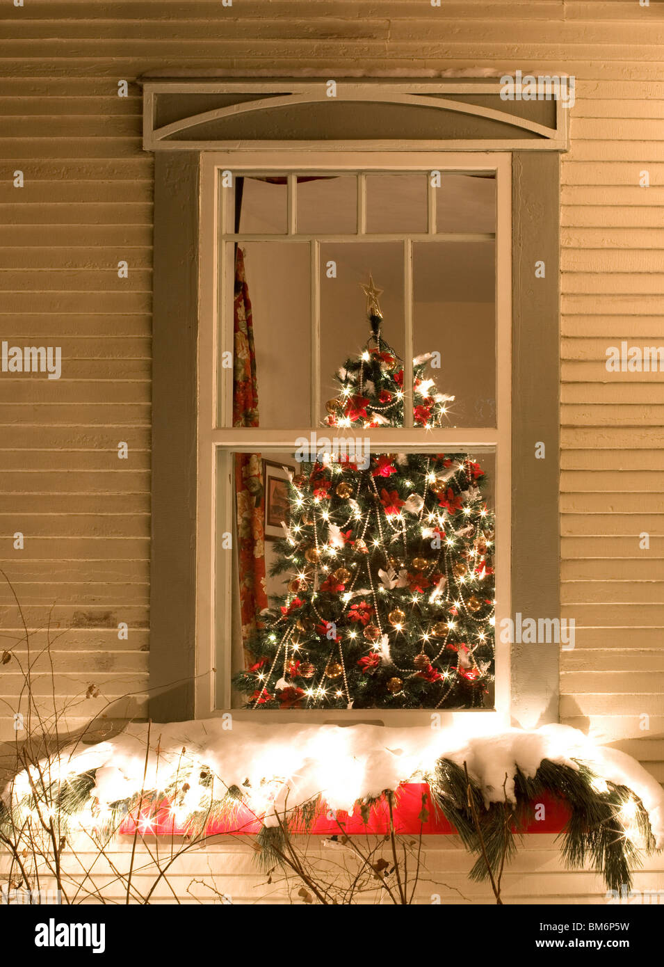 View Through A Window Of A Christmas Tree Covered In Decorations And ...