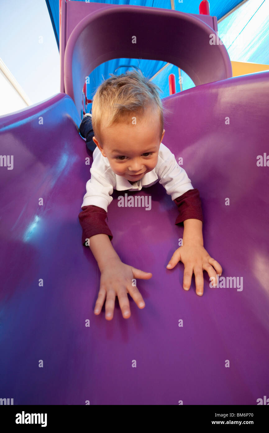 Child going down playground slide hi-res stock photography and images ...