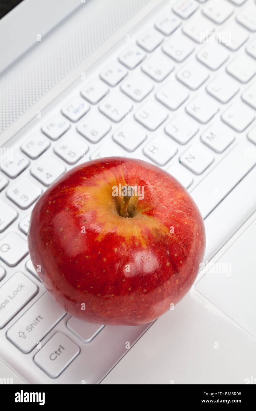 Computer Keyboard and red apple close up Stock Photo - Alamy