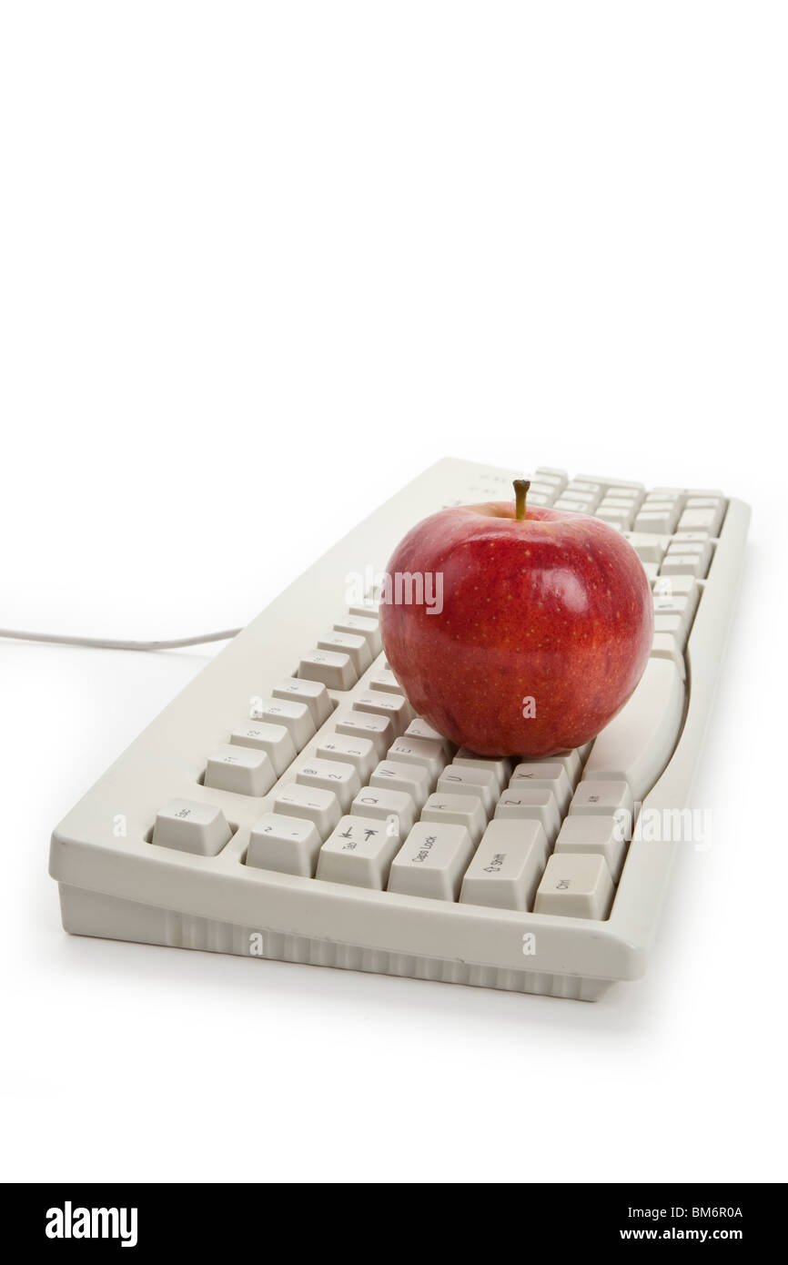 Computer Keyboard and red apple close up Stock Photo - Alamy