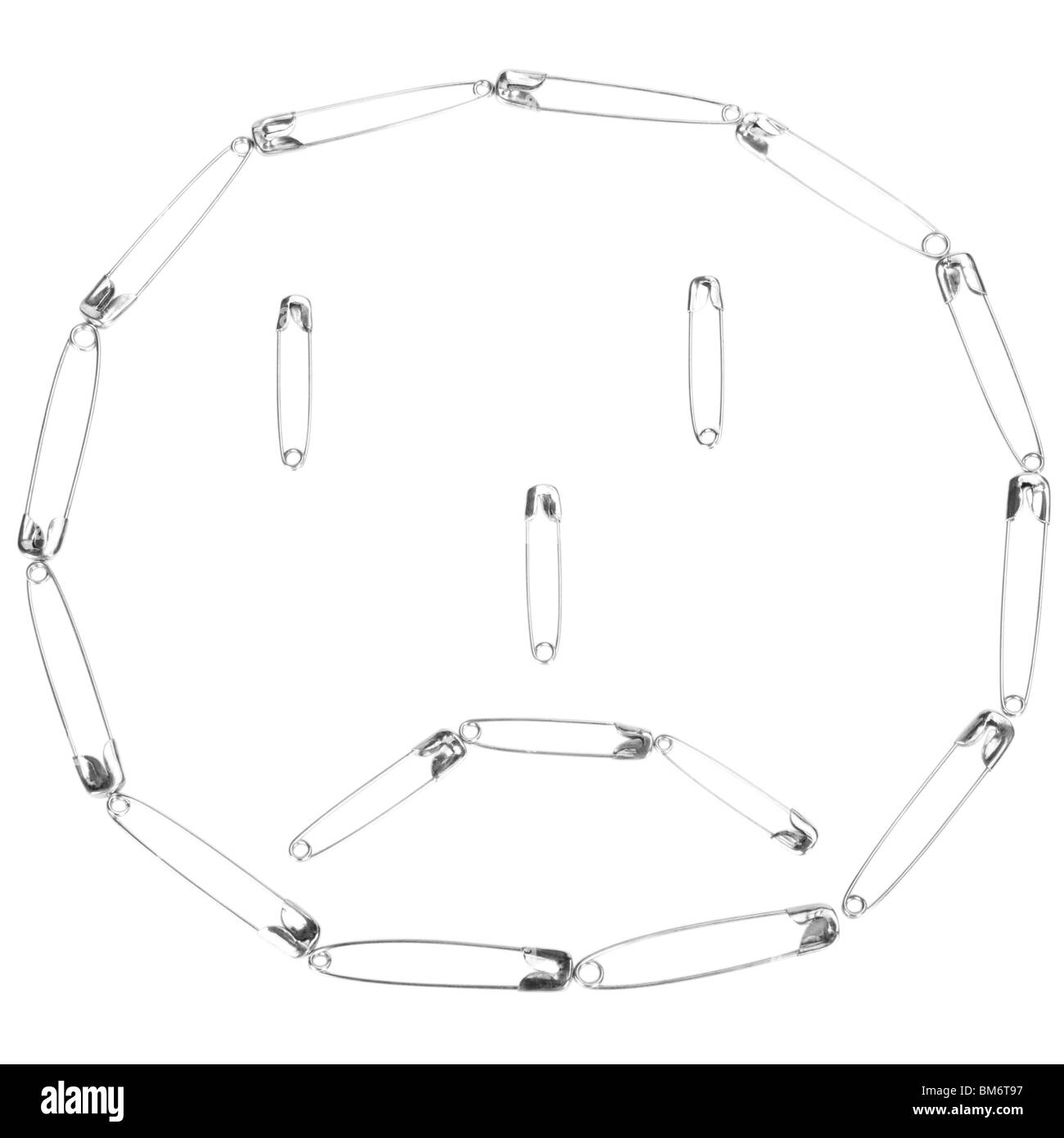 Sad face made of safety pins Stock Photo - Alamy