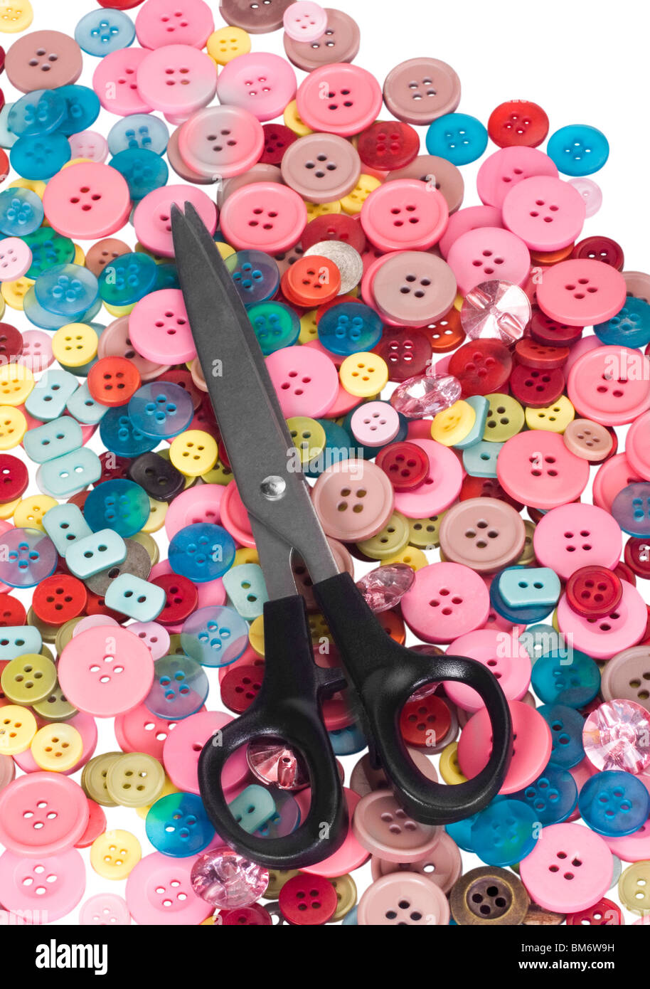 Scissors on a heap of buttons Stock Photo - Alamy