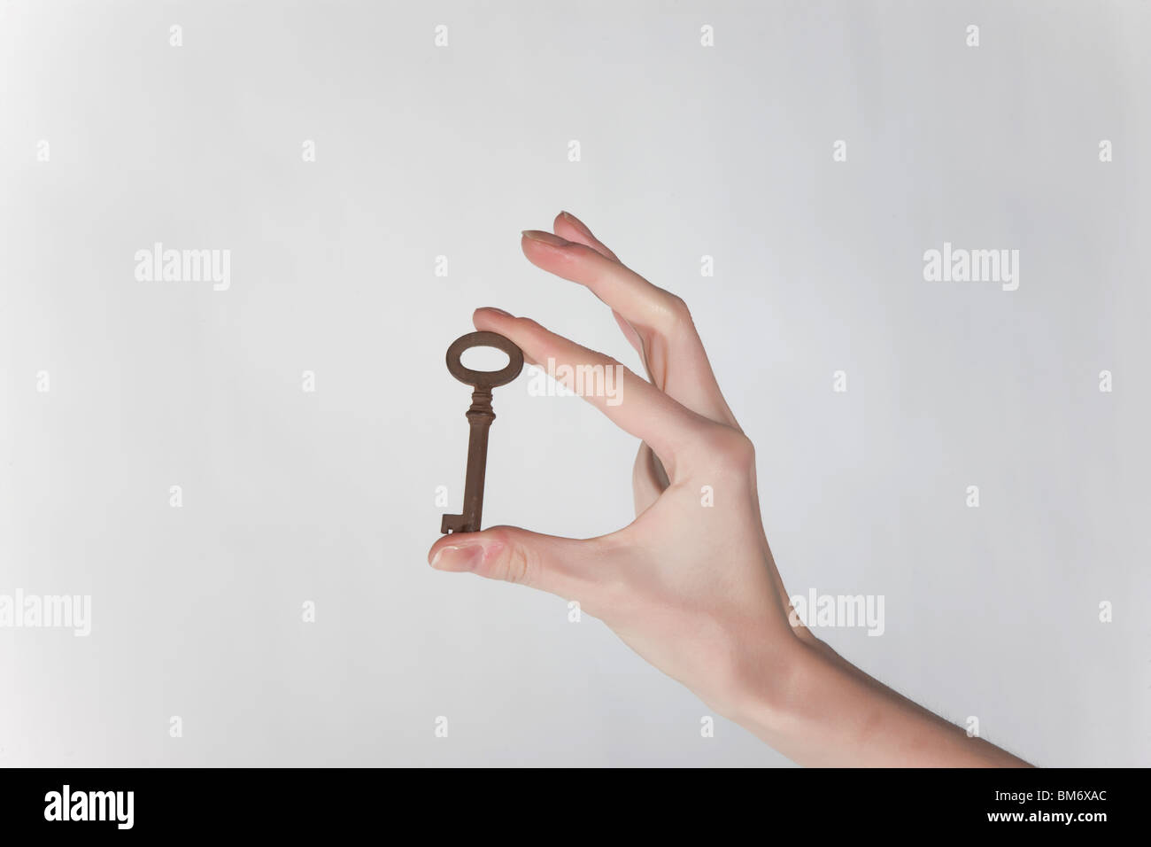 Hand holding keys isolated on the white Stock Photo - Alamy
