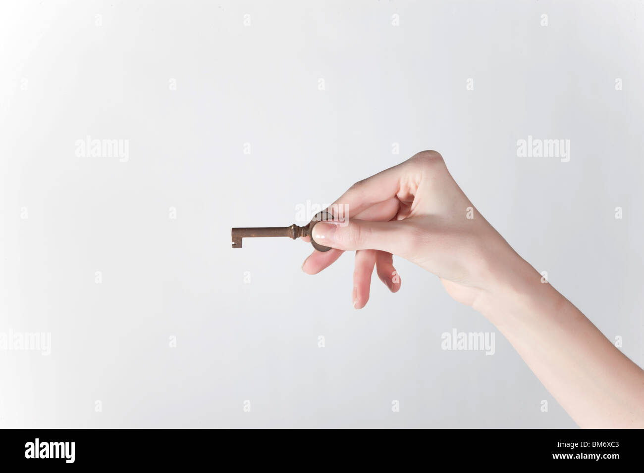 Hand holding keys isolated on the white Stock Photo - Alamy