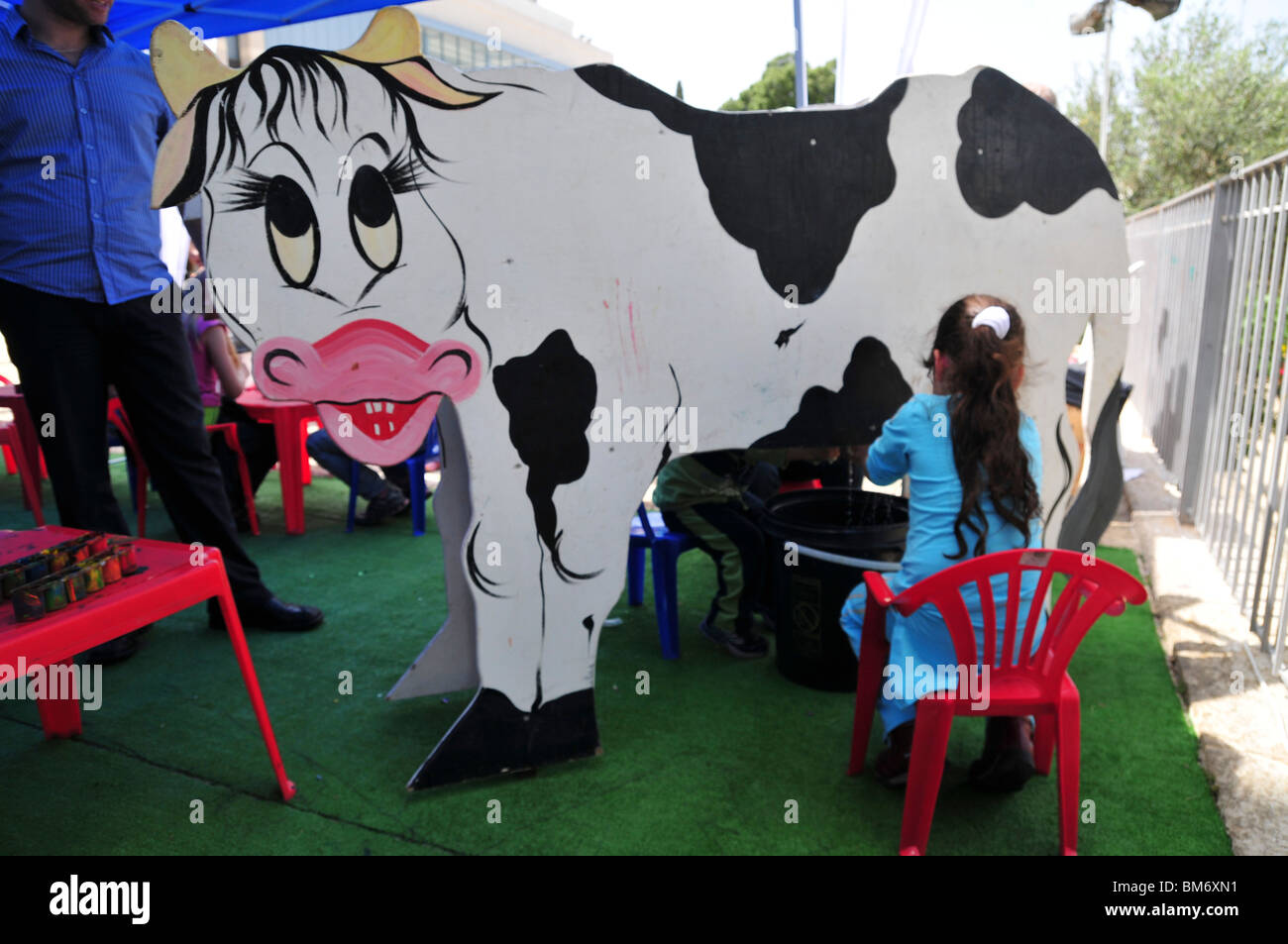 Israel, Haifa, Municipal Theatre Children's Play festival cow milks a ...