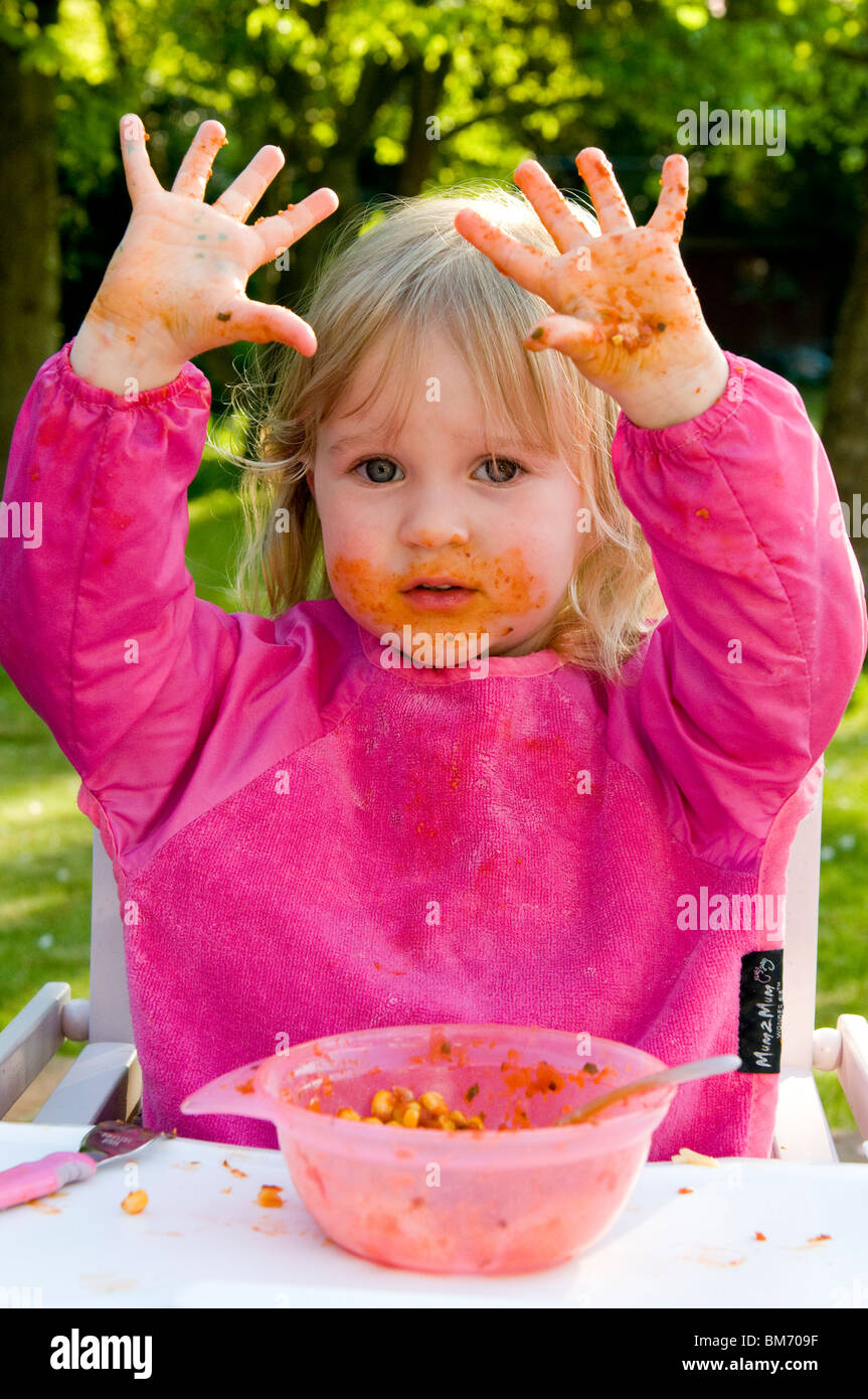 GIRL TODDLER, ENJOYS GETTING MESSY WHILE EATING PASTA IN TOMATO SAUCE ...
