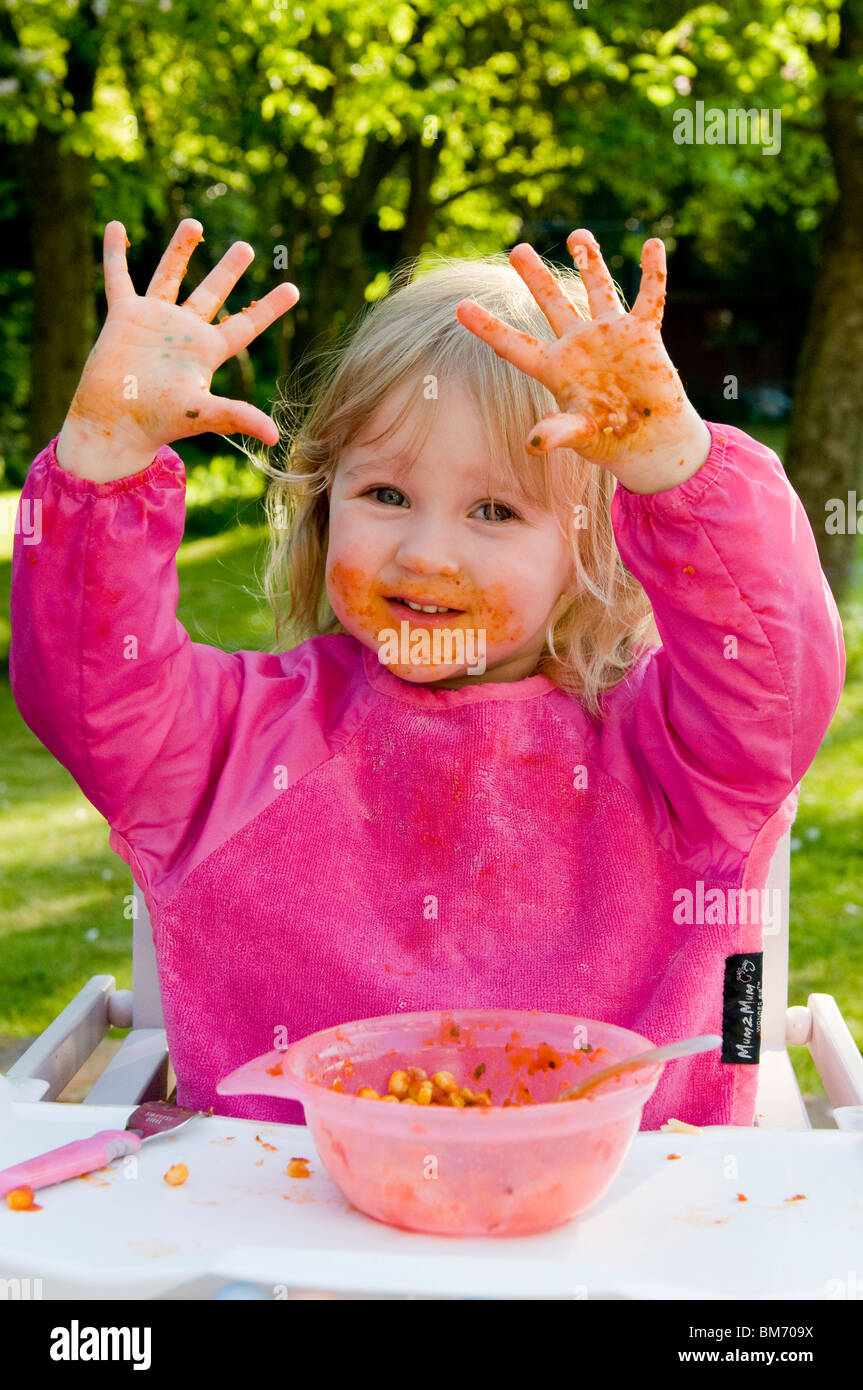 GIRL TODDLER, ENJOYS GETTING MESSY WHILE EATING PASTA IN TOMATO SAUCE ...