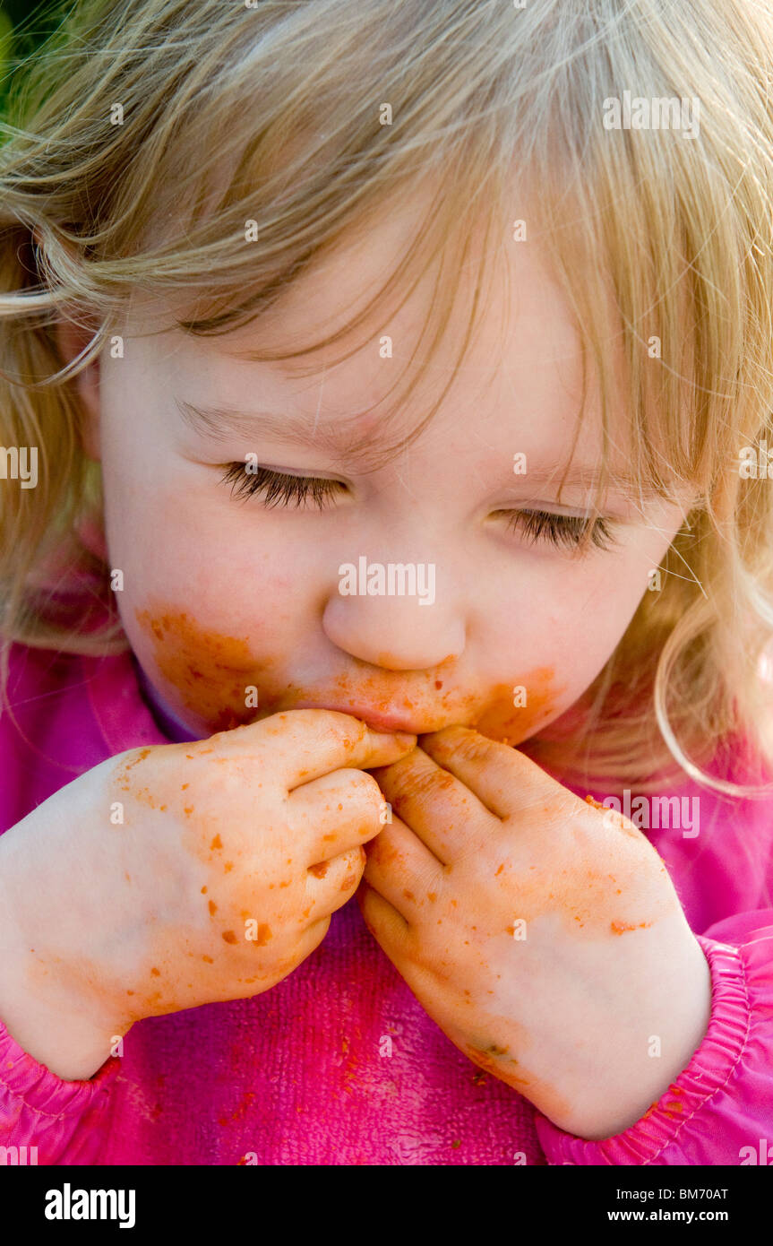 GIRL TODDLER, ENJOYS GETTING MESSY WHILE EATING PASTA IN TOMATO SAUCE ...