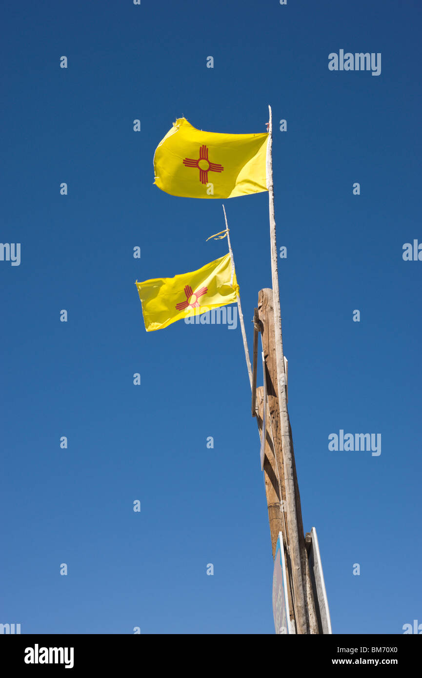 Dual flags of the state of New Mexico fly proudly under the deep blue ...