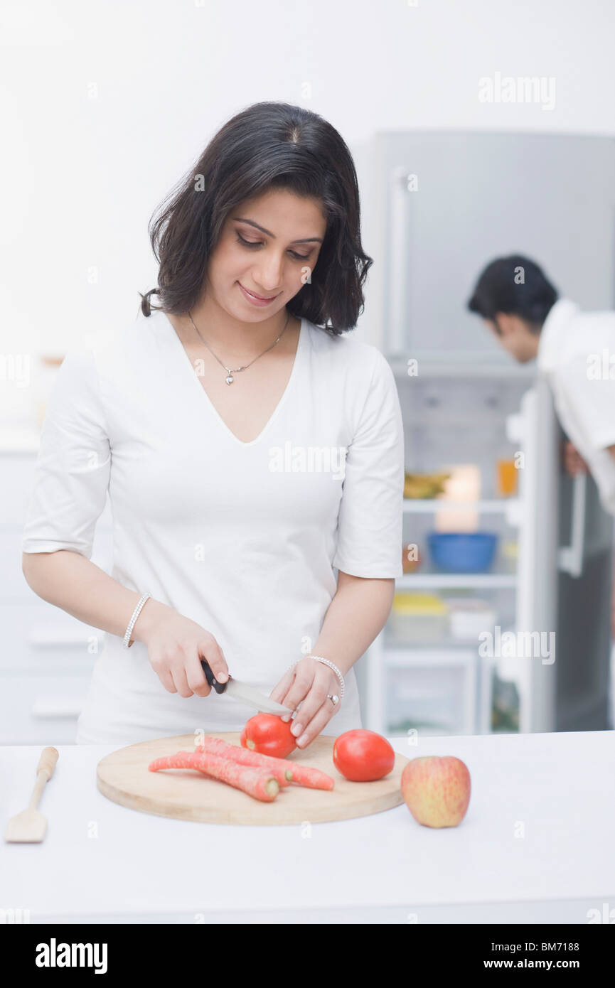 Woman chopping vegetables in the kitchen Stock Photo - Alamy