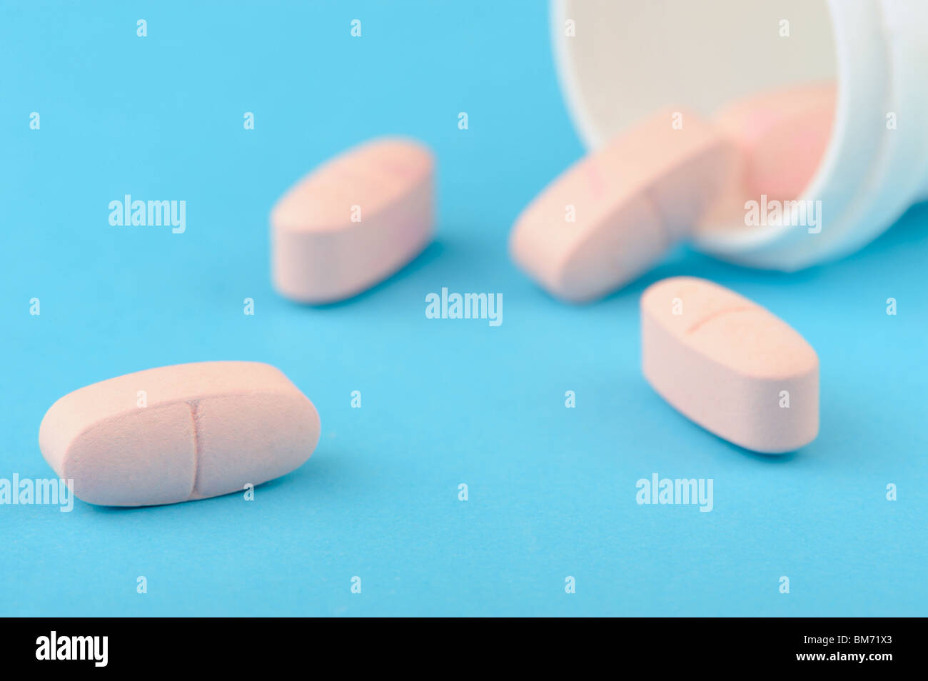 Pink tablets in white plastic packing. A blue background Stock Photo ...