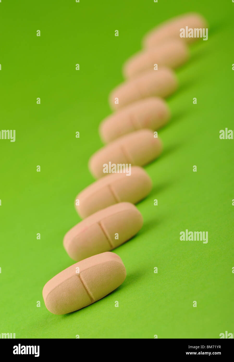 set red tablets on green background. Photo closeup Stock Photo - Alamy