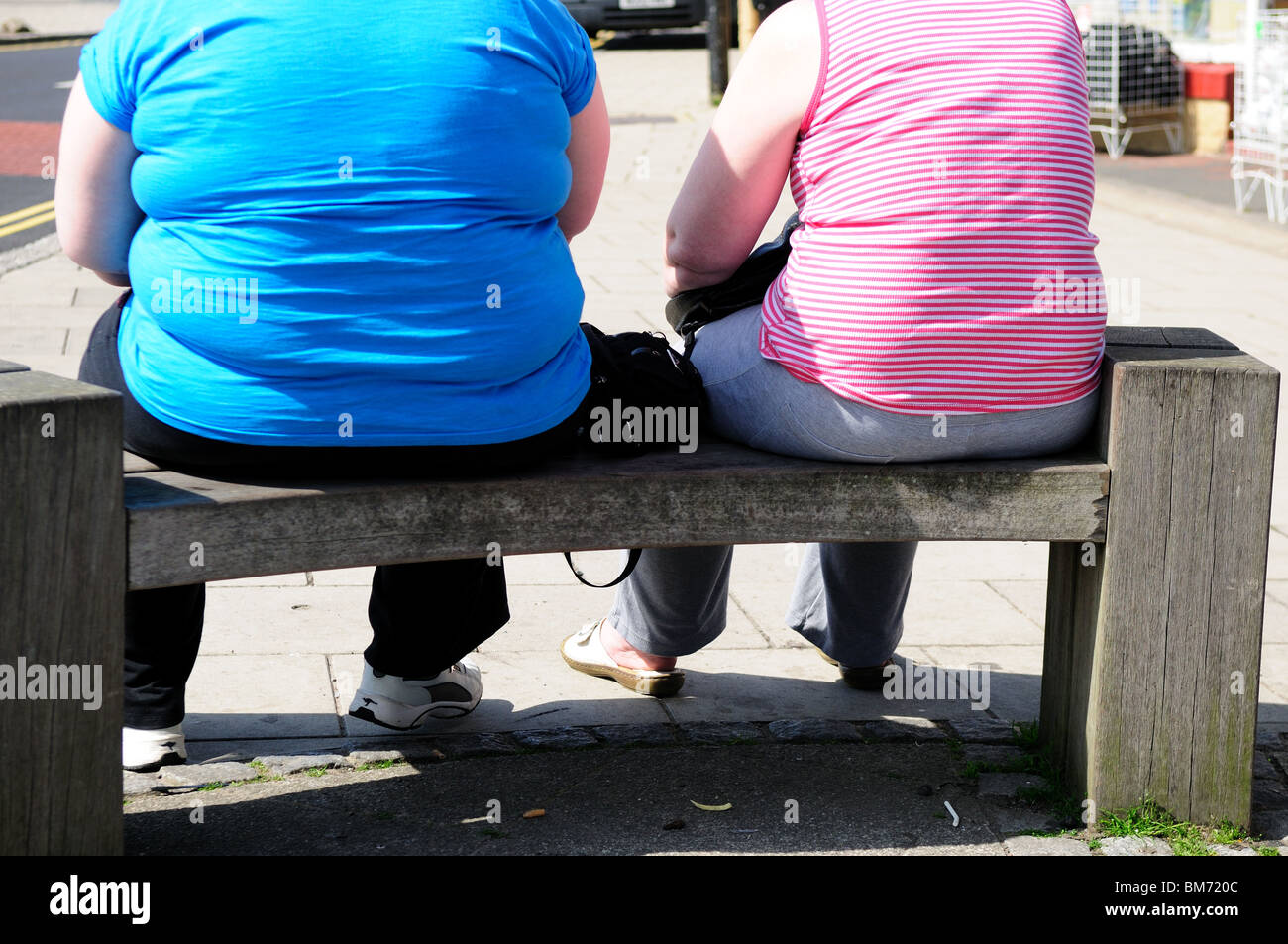 Overweight People Sitting on Wooden Bench Stock Photo - Alamy