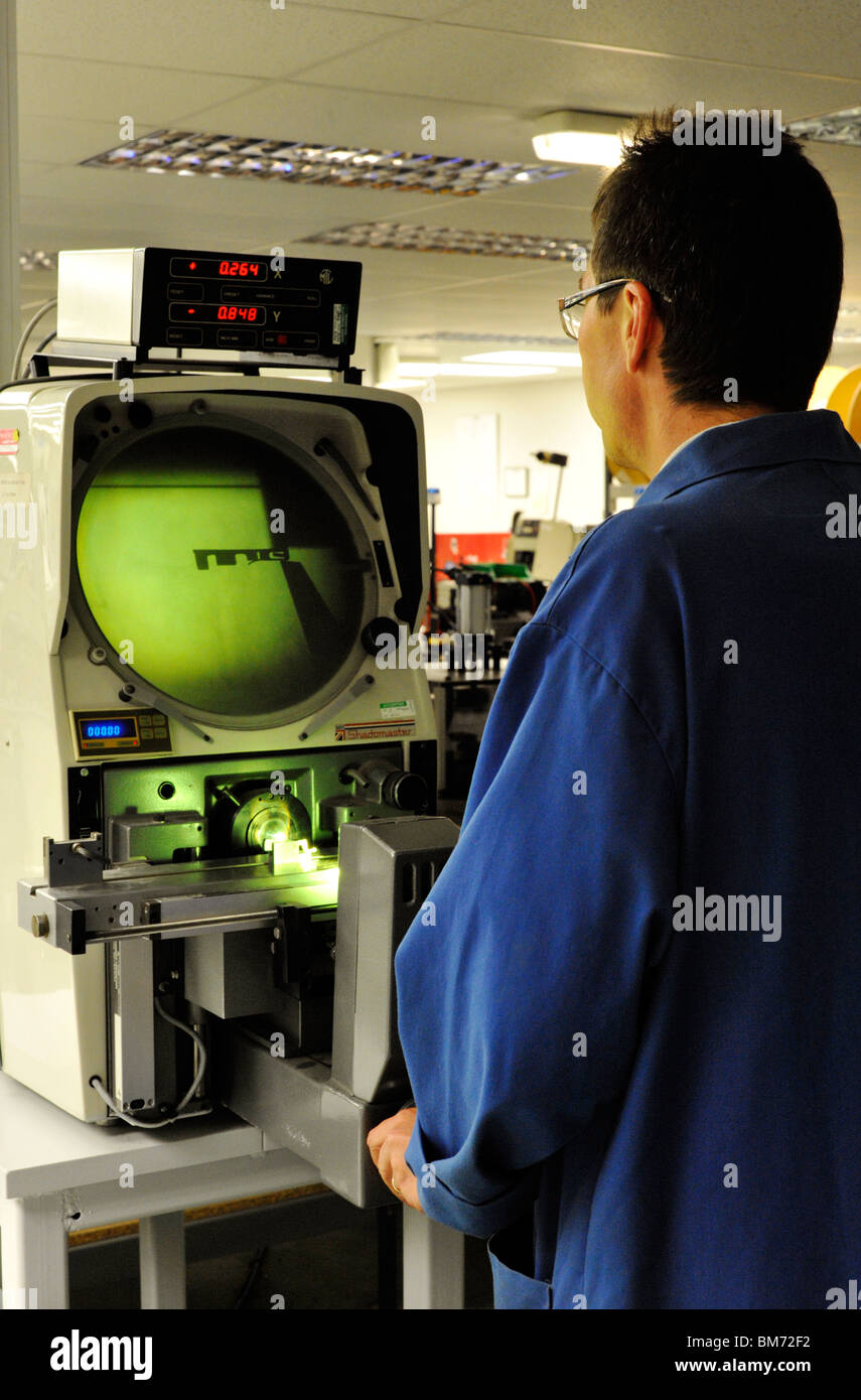 factory worker using shadowgraph to check measurements Stock Photo - Alamy