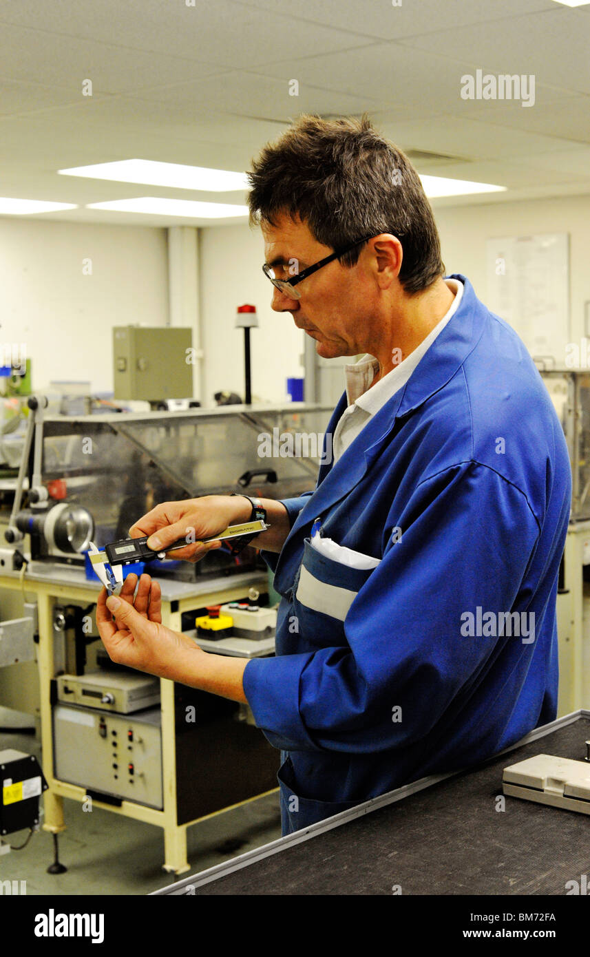 factory worker using caliper to check measurements Stock Photo - Alamy