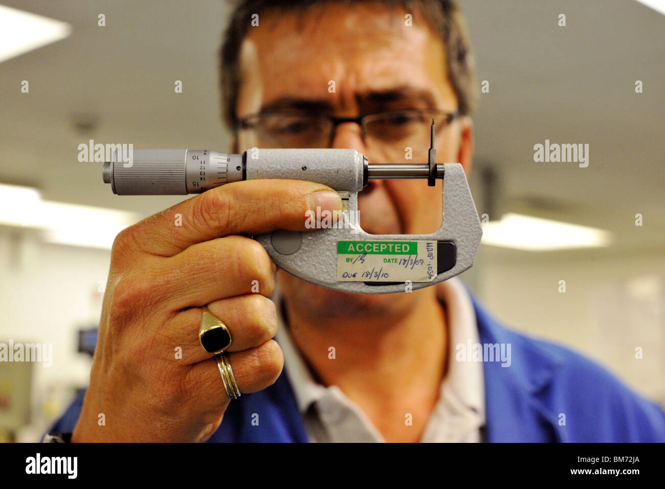 factory worker using micrometer to check measurements Stock Photo - Alamy