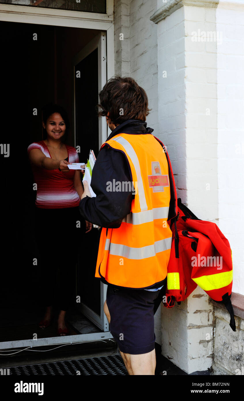 Royal mail postman delivers letters hi-res stock photography and images ...