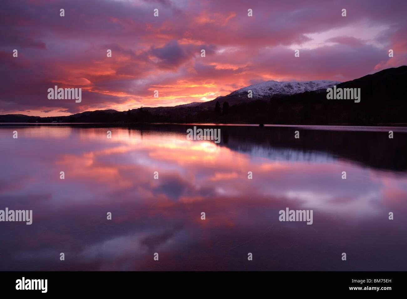 Sun setting over Coniston Water Stock Photo - Alamy