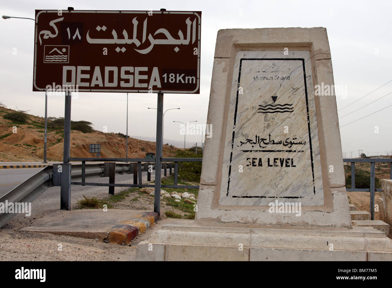 Road signs marking the sea level high above the Dead Sea in Jordan ...