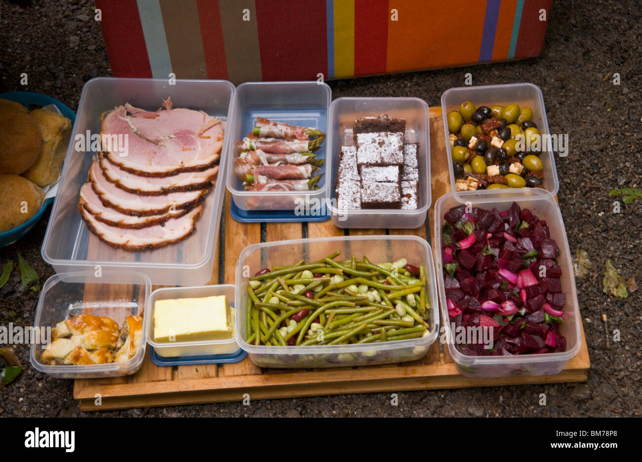 Selection of cold meat and salad served for lunch on outdoor bushcraft ...