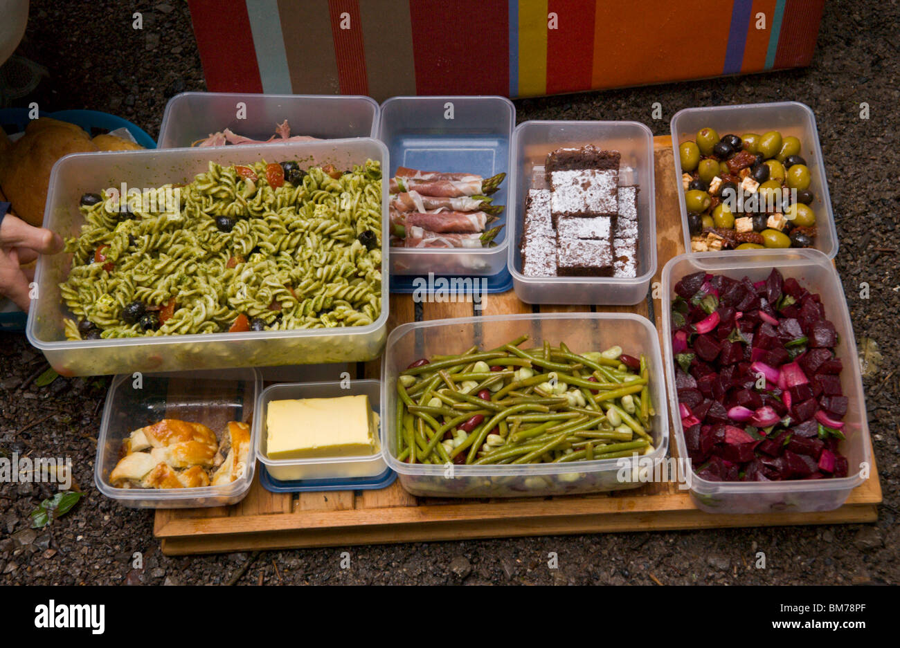 Selection of cold meat and salad served for lunch on outdoor bushcraft ...