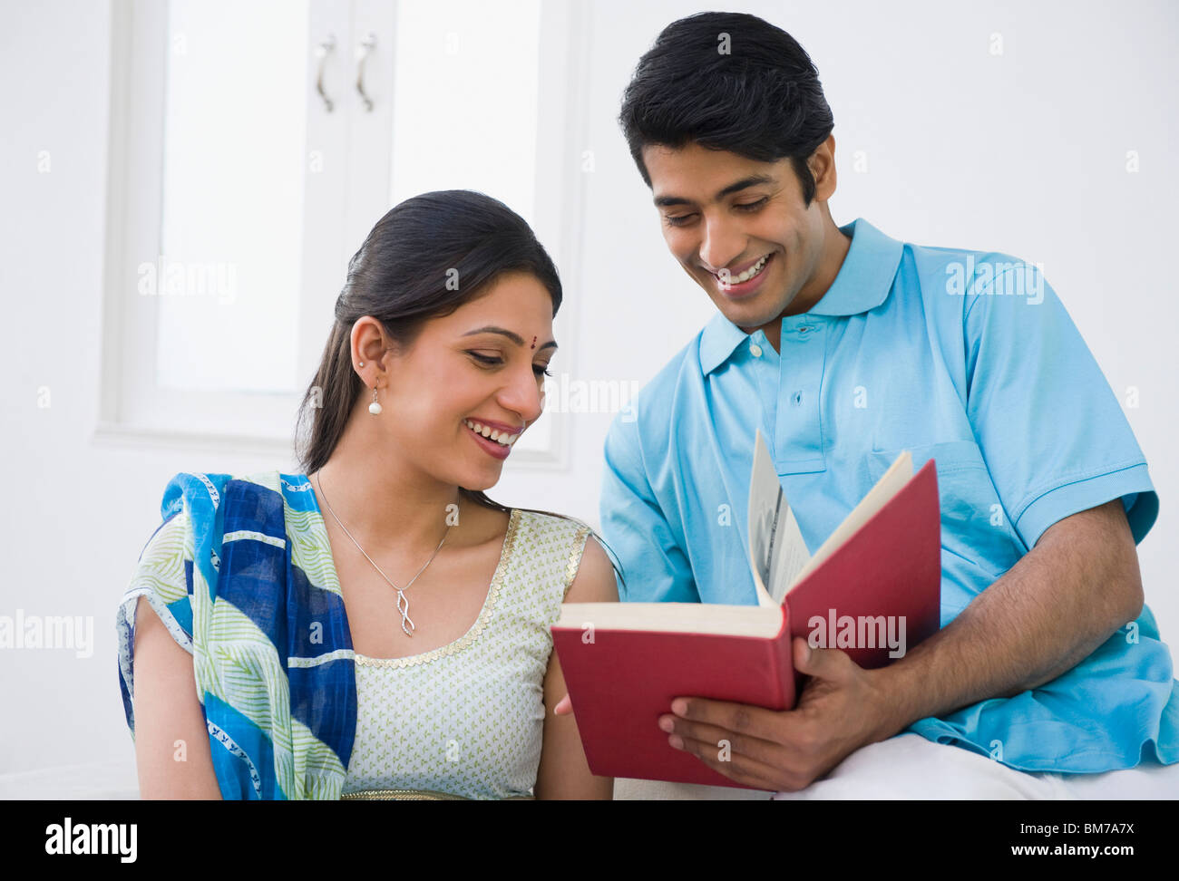 Couple sharing a book Stock Photo - Alamy