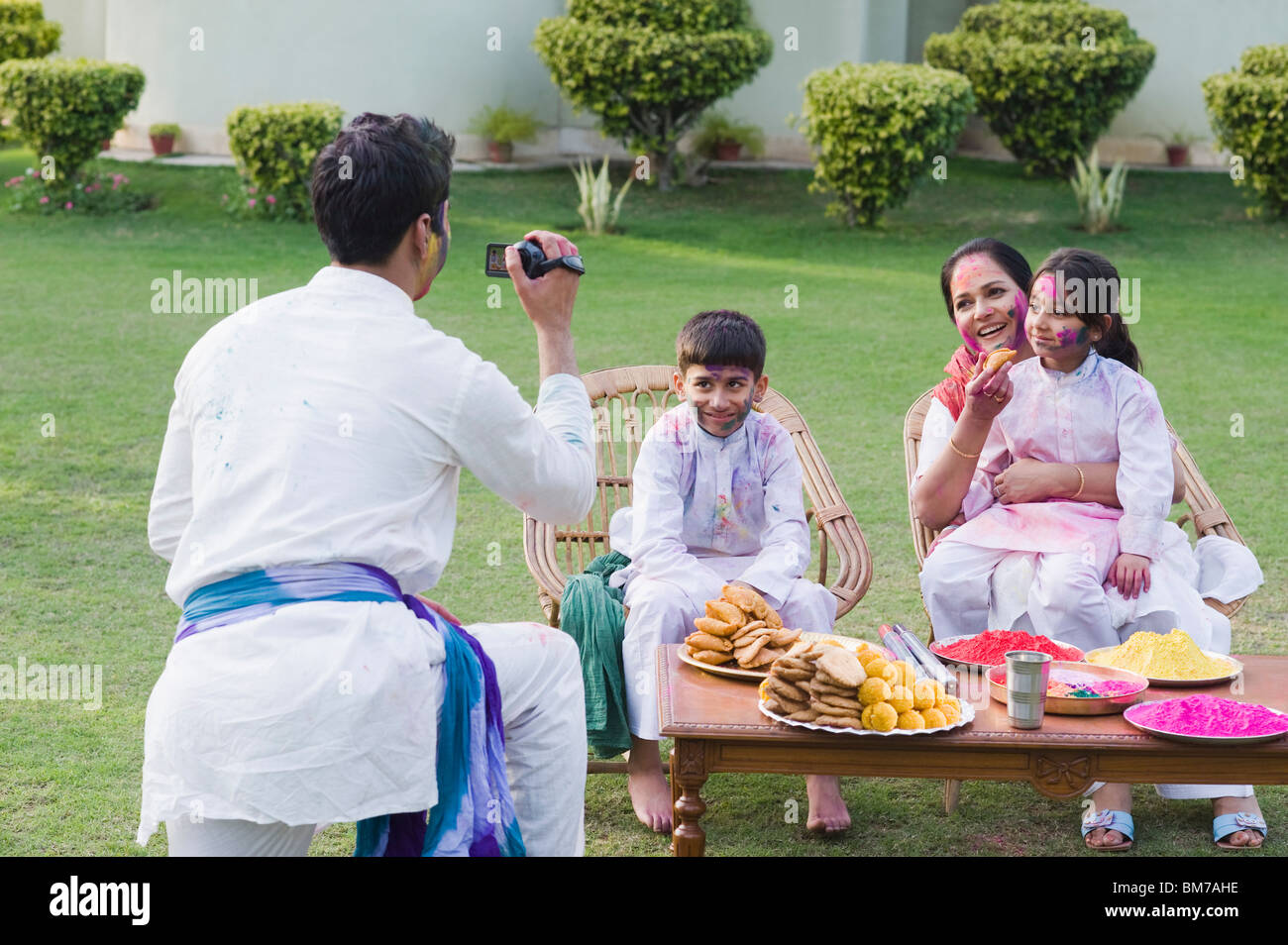 Man filming his family with a video camera on holi Stock Photo - Alamy