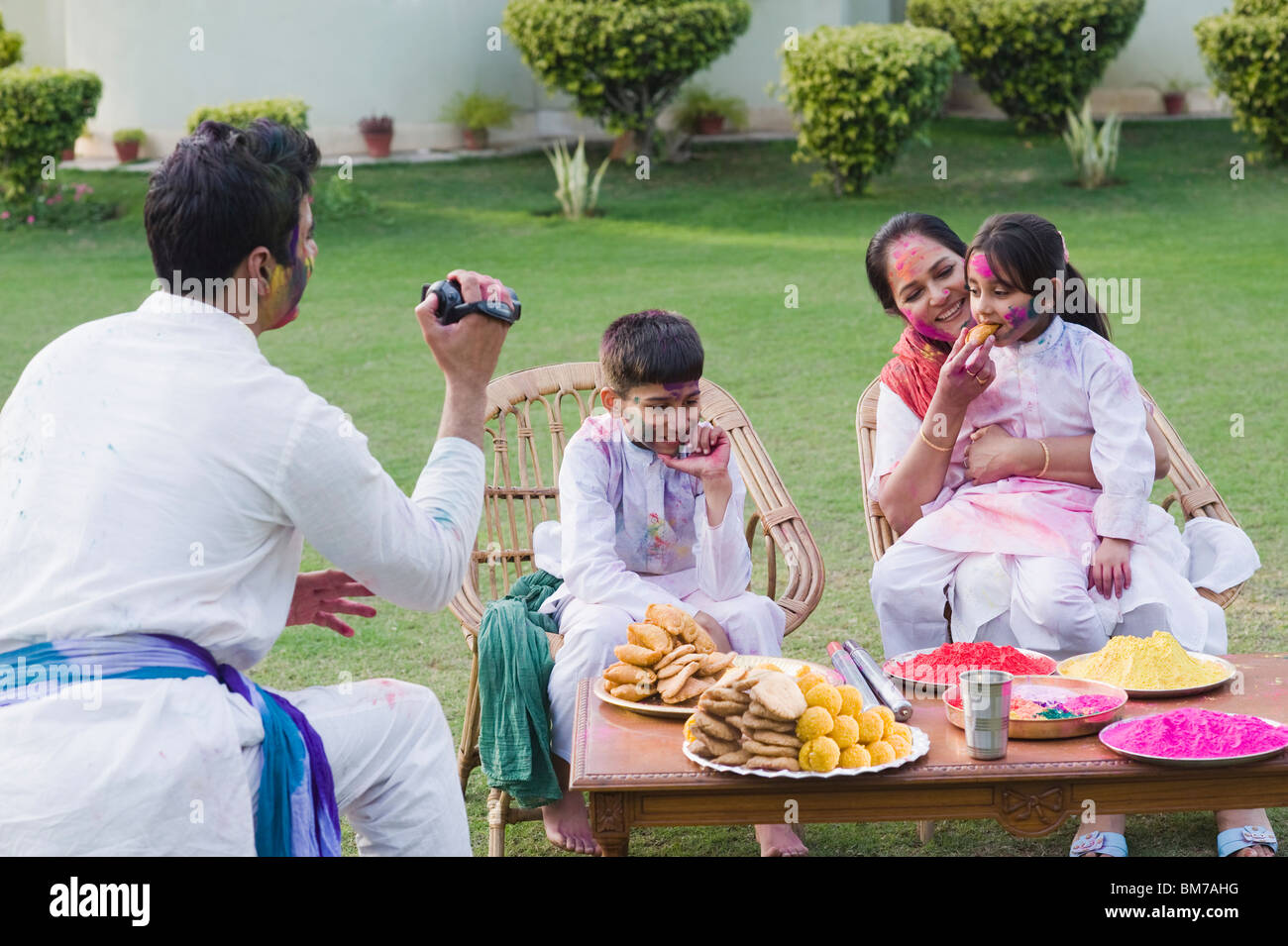 Man filming his family with a video camera on holi Stock Photo - Alamy