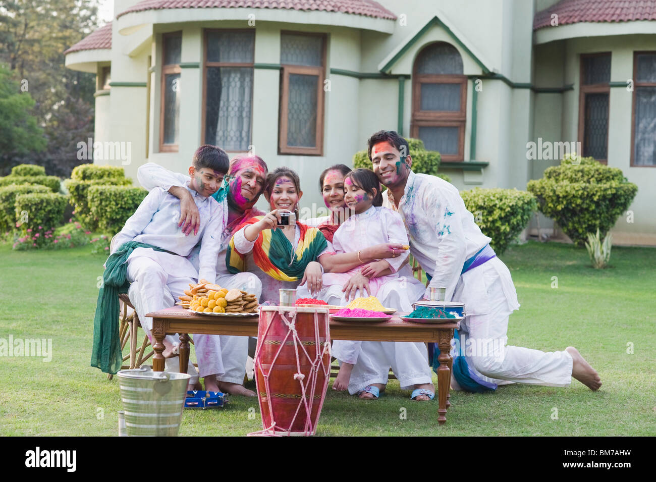 Family taking a picture of themselves with a camera on holi Stock Photo ...