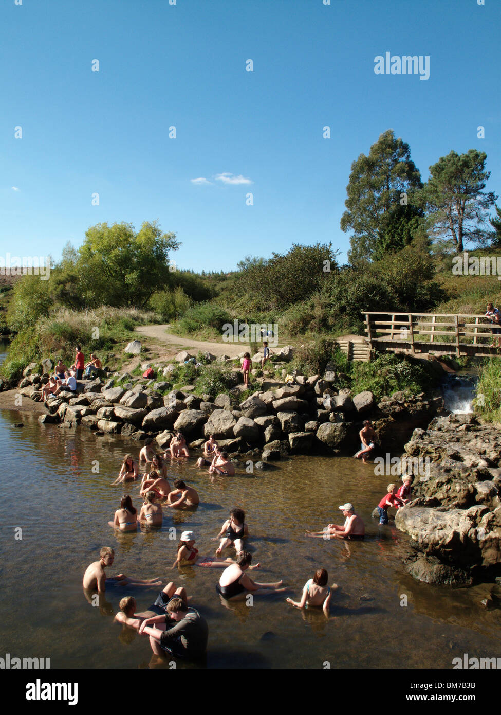 People bathing in a thermal spring on the edge of the Waikato River in ...